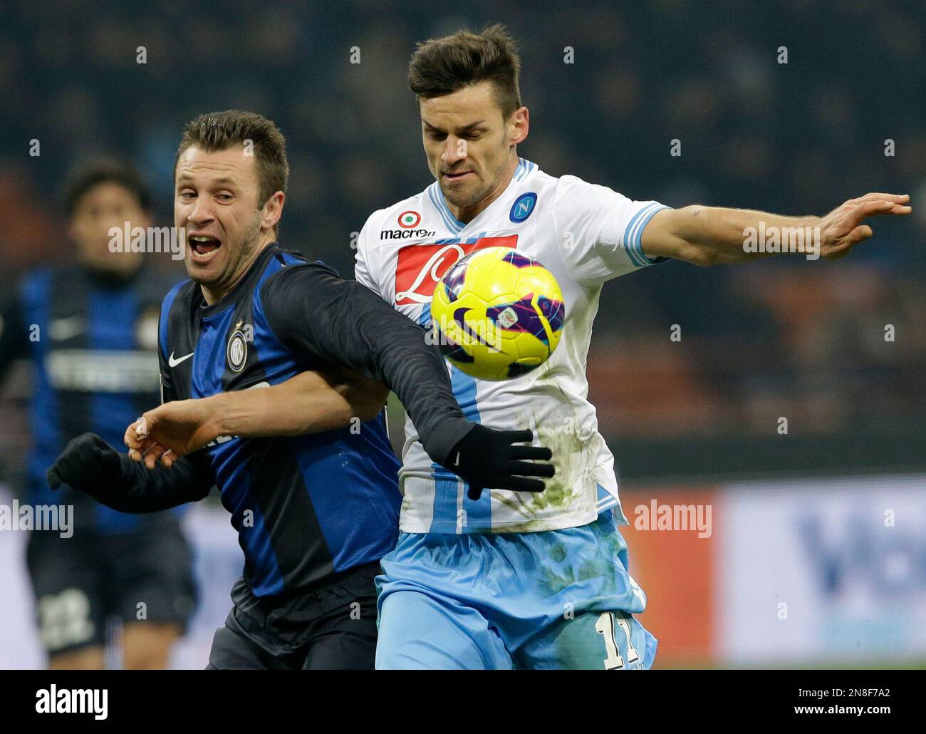 Inter Milan forward Antonio Cassano, left, challenges for the ball with ...