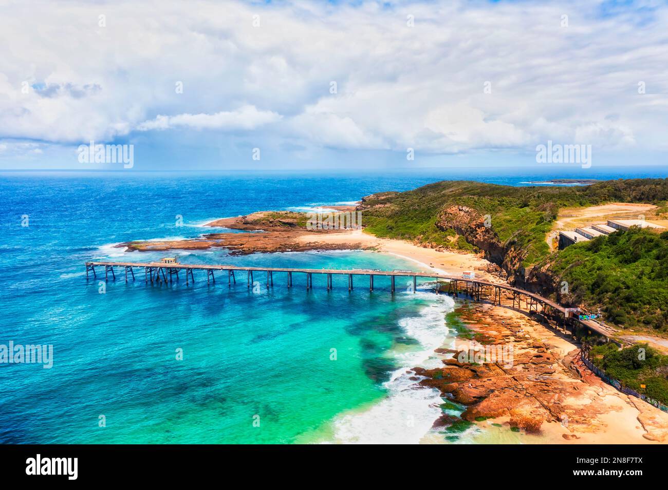 Scenic historic coal loader timber jetty at Catherine hill bay beach of ...