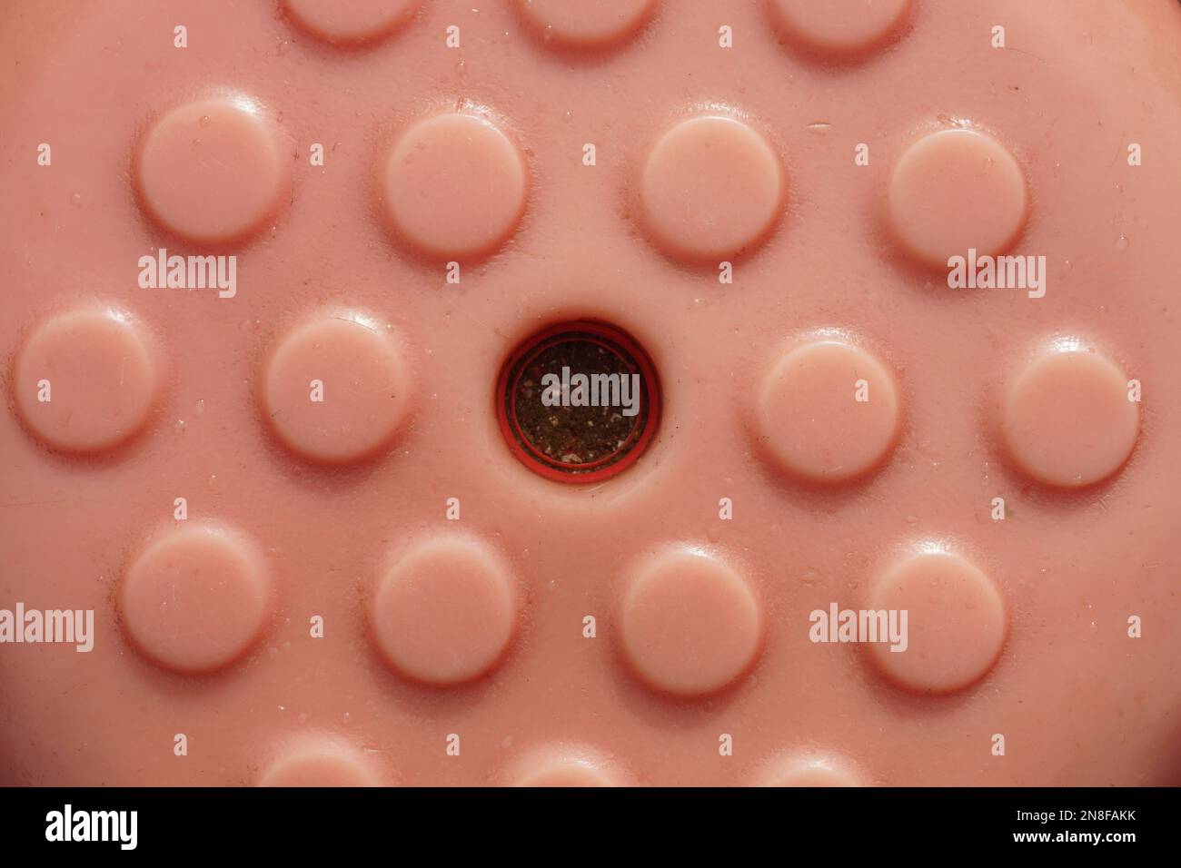 round reliefs on a light pink plastic background Stock Photo - Alamy