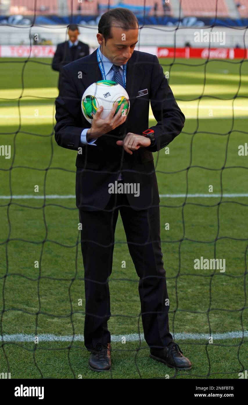 Referee Cuneyt Cakir of Turkey checks his referee's watch as he tests ...