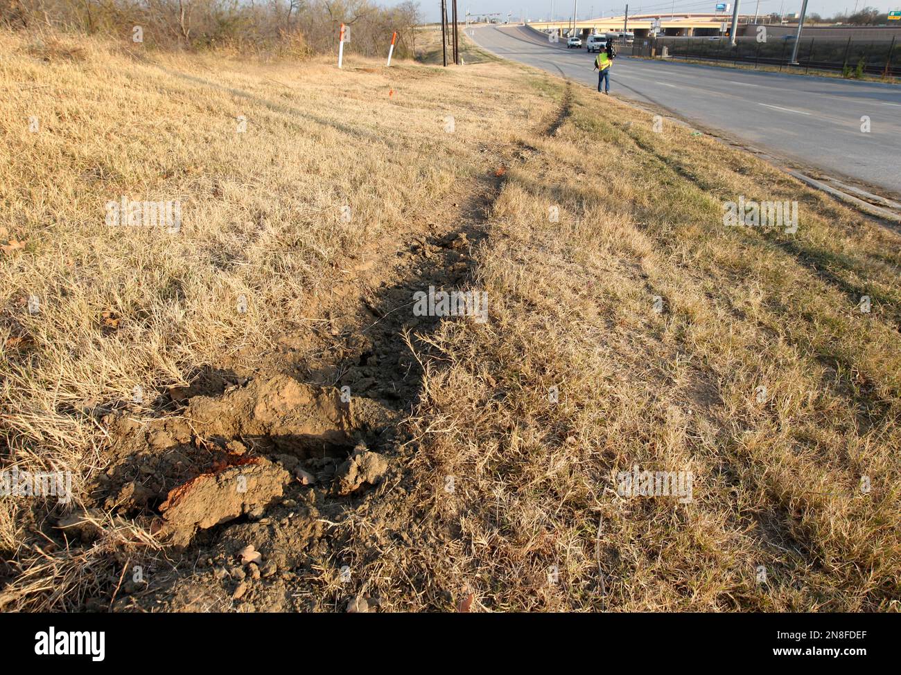 Tire ruts are seen on the ground with skid marks, at rear on road, at ...