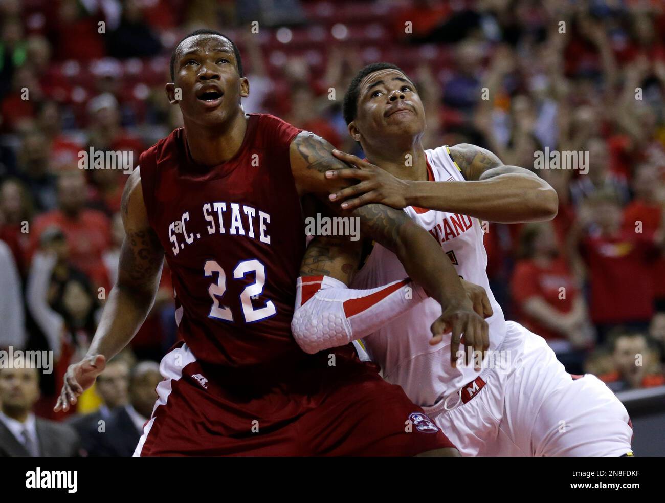 South Carolina State forward Matthew Hezekiah, left, and Maryland guard ...