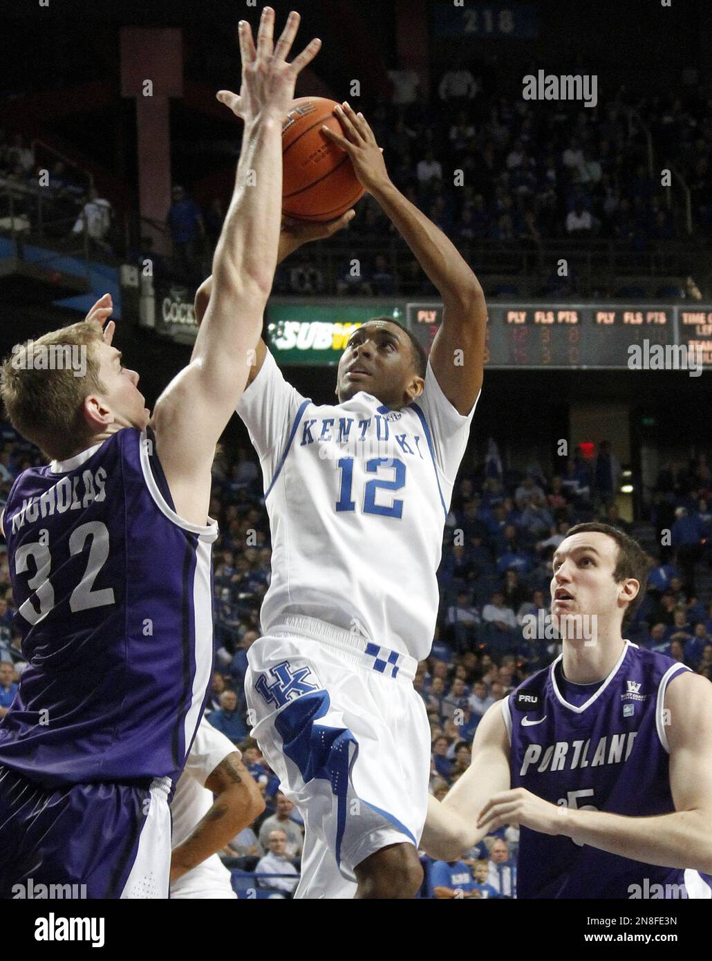 Kentucky's Ryan Harrow (12) shoots between Portland's Ryan Nicholas (32 ...