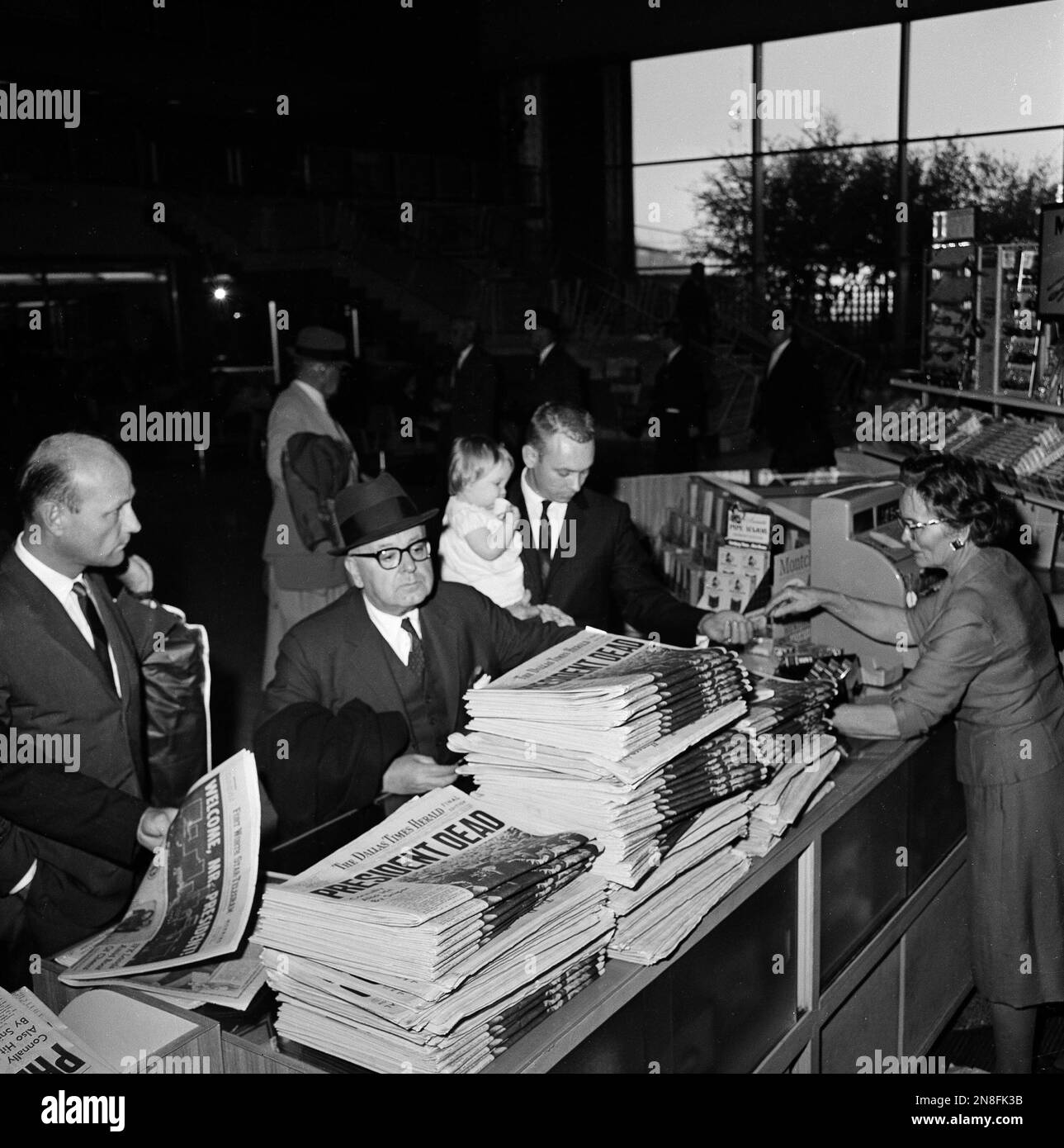 People look over stacks of the Dallas Times Herald final edition of the ...