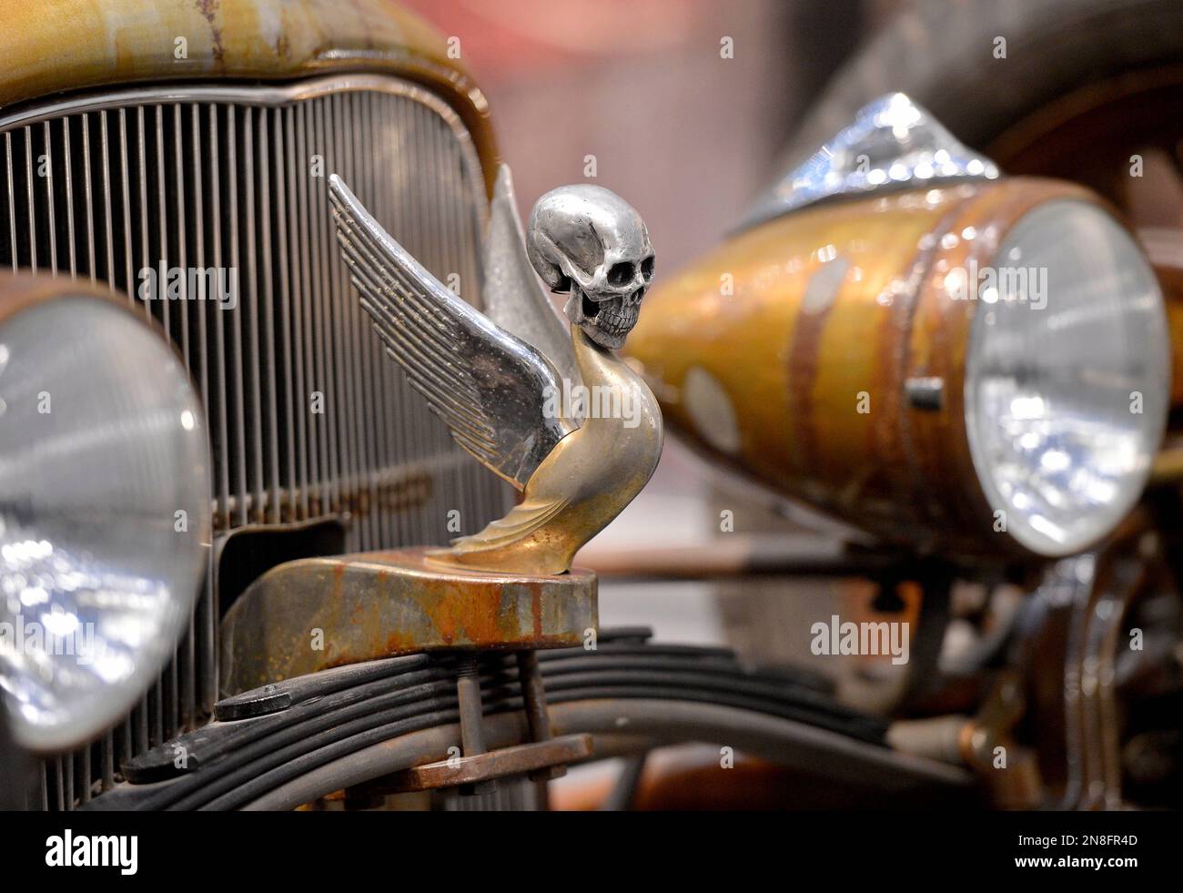 A hood ornament with a skull is pictured on a rat rod custom car at the ...