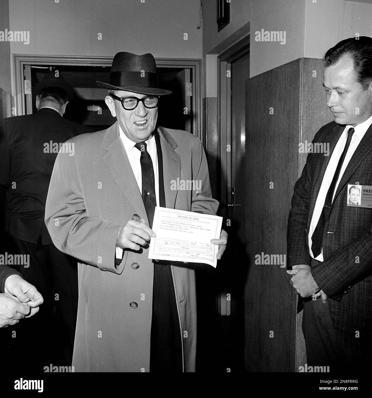 Earle Cabell, former mayor of Dallas, Tex., displays his subpoena as a witness at the change of ...