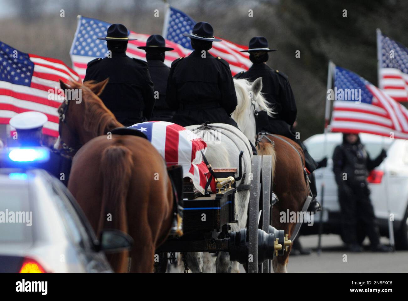 The casket of Cold Spring Police Officer Tom Decker proceeds in a horse ...
