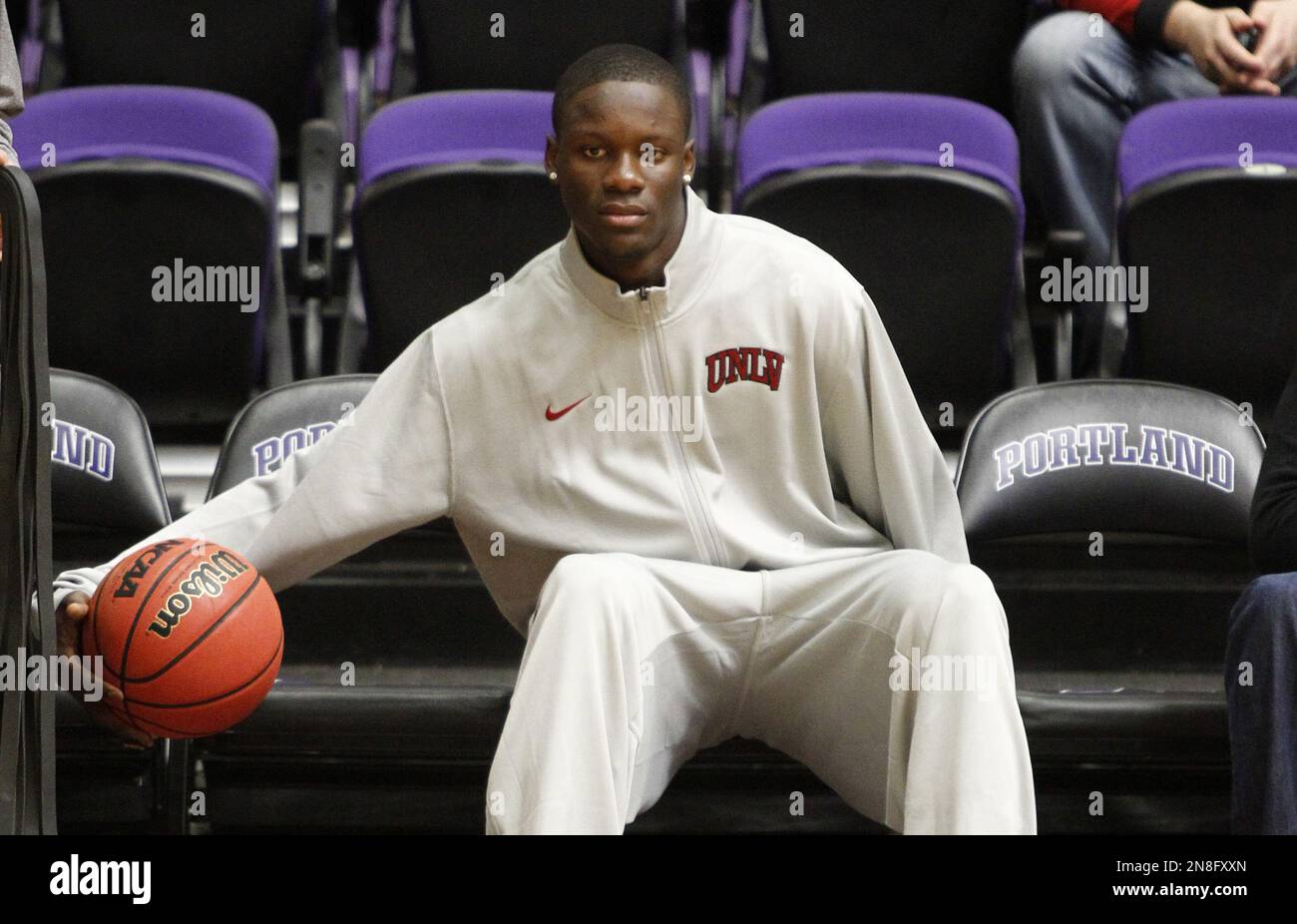 UNLV forward Mike Moser plays with a ball on the bench before the team ...