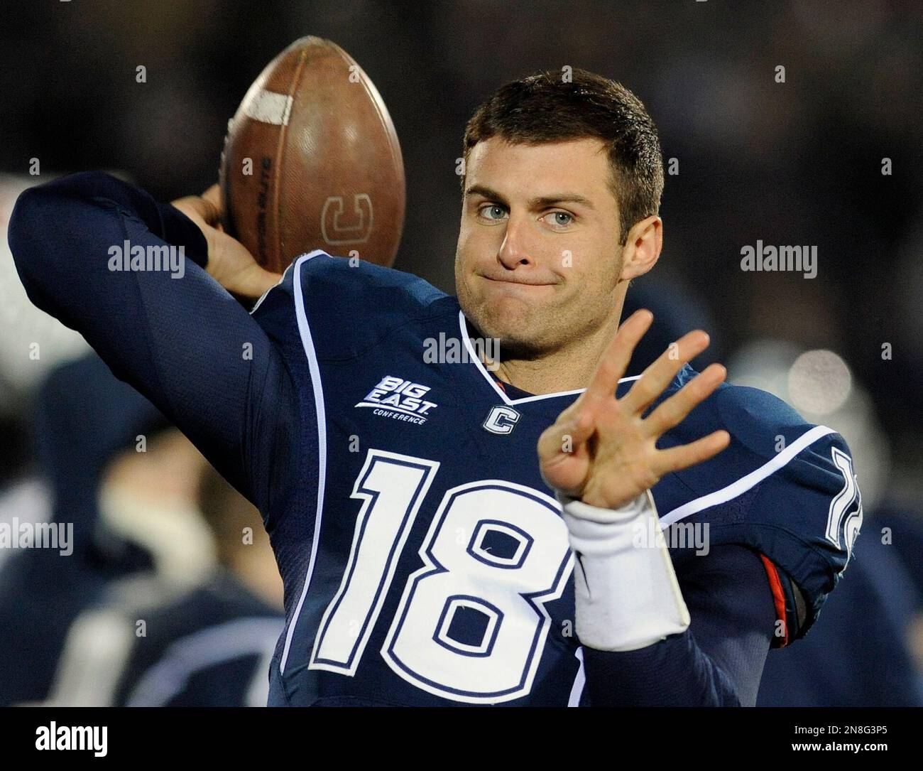 Connecticut quarterback Johnny McEntee (18) warms up during the second ...