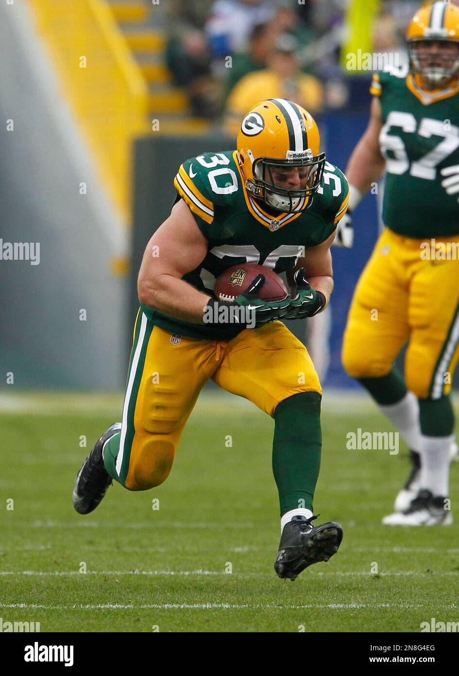 Green Bay Packers fullback John Kuhn rushes against the Minnesota ...