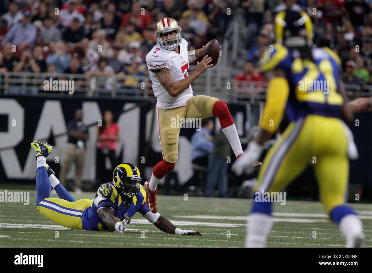 San Francisco 49ers quarterback Colin Kaepernick, right, runs away from ...