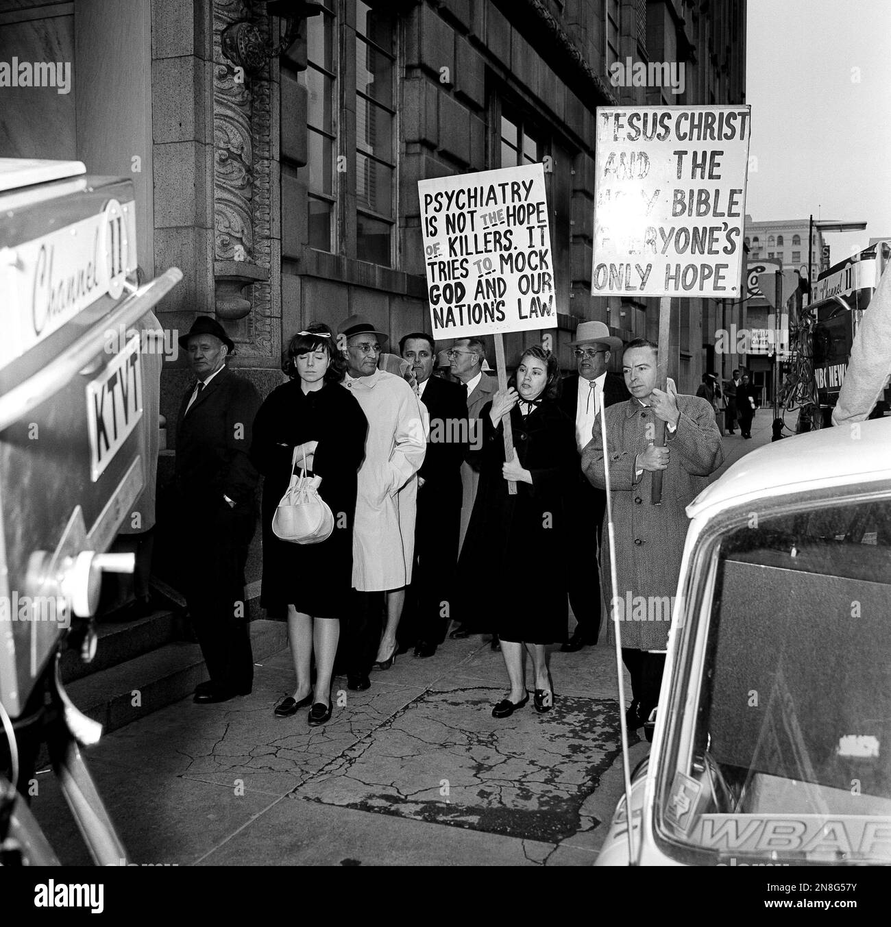 Protesters hold placards outside the courthouse where Jack Ruby's trial ...