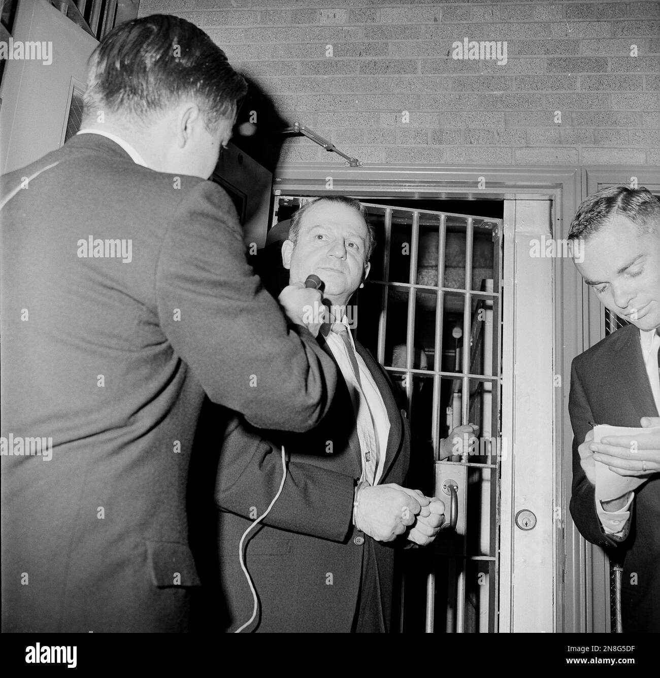 Jack Ruby, who shot and killed Lee Harvey Oswald, is shown talking to a ...