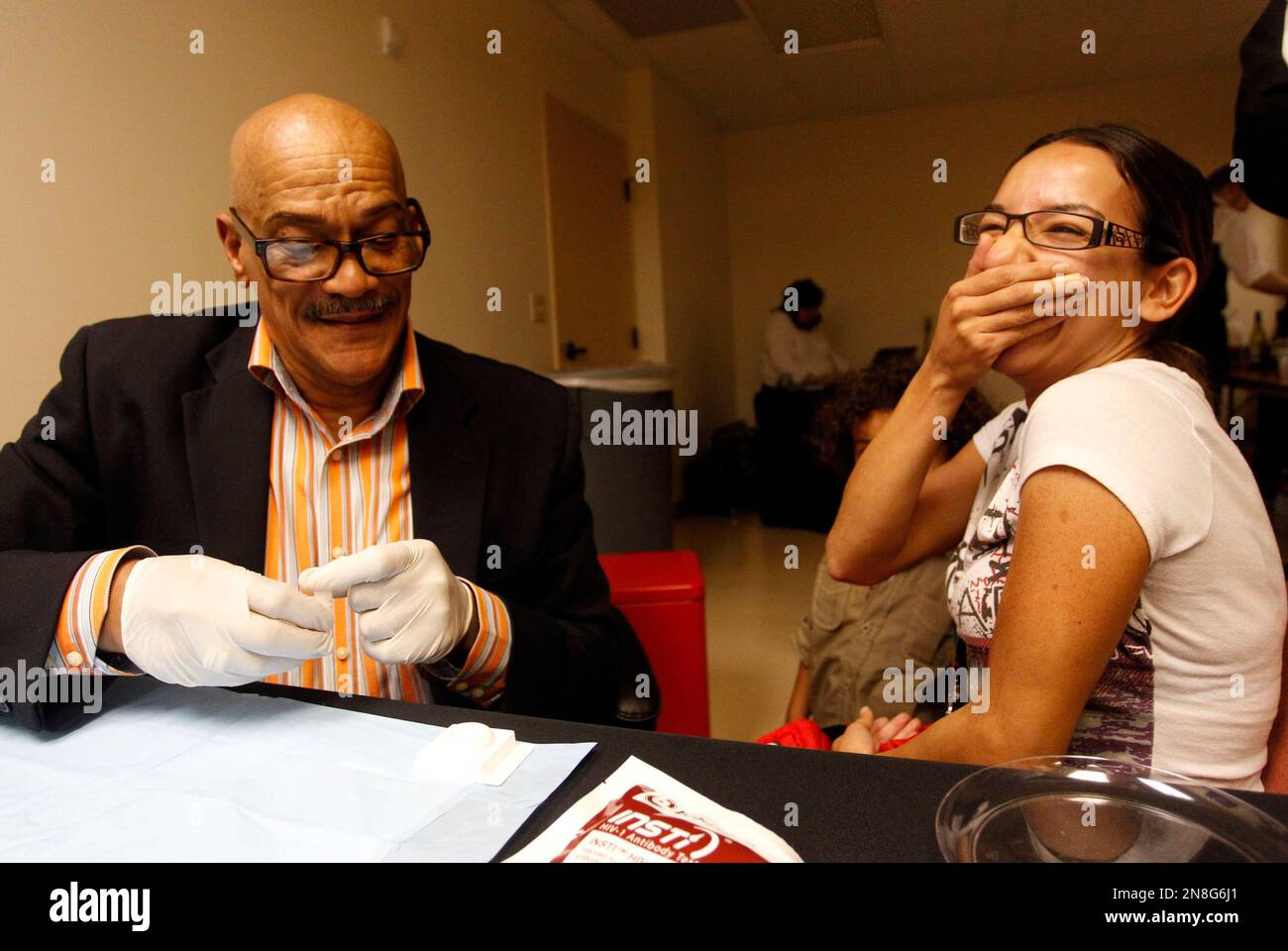 AHF HIV testing Counselor, Boyd Bowen demonstrates the Insti HIV-1 ...