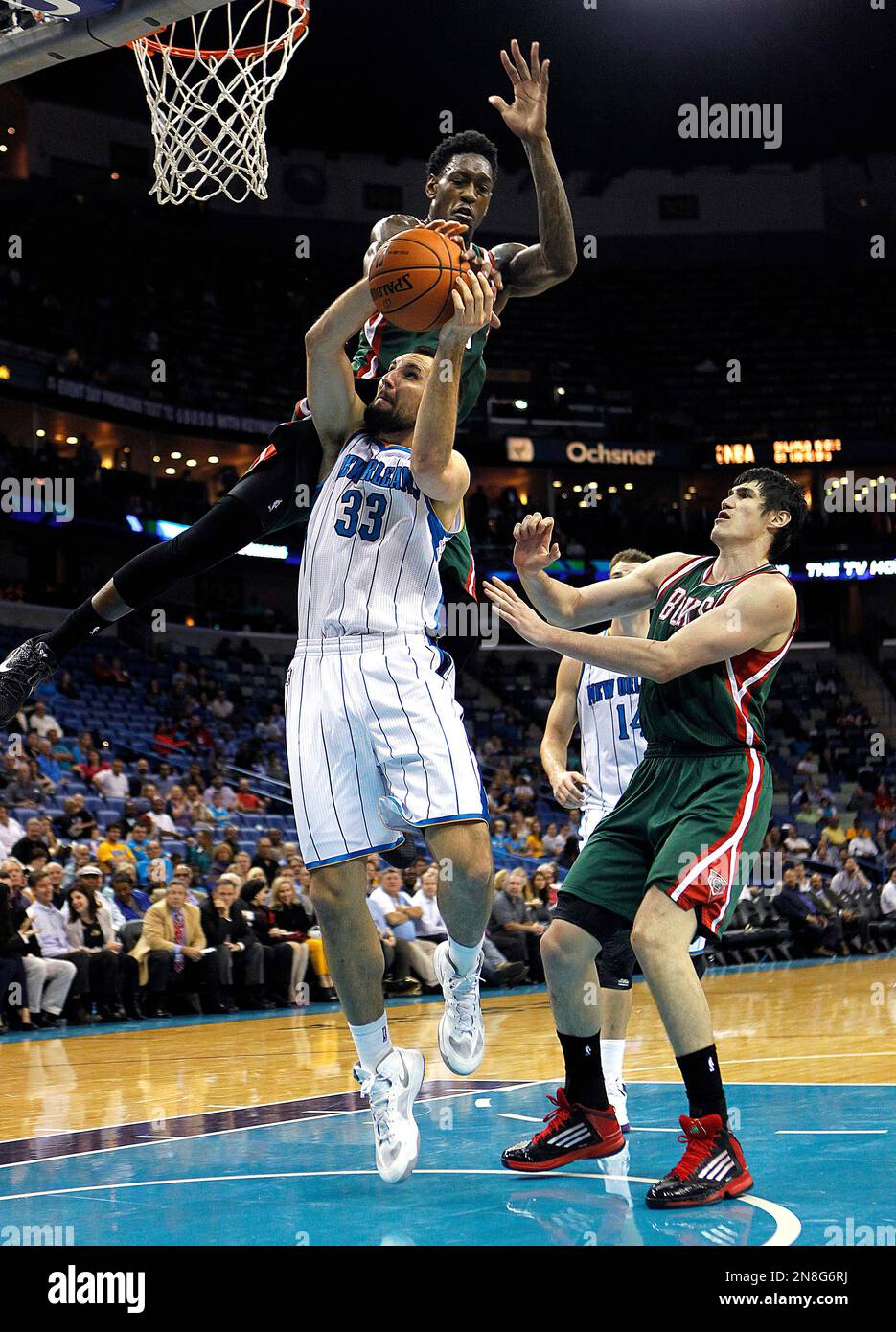 Milwaukee Bucks center Larry Sanders, top, fouls New Orleans Hornets ...