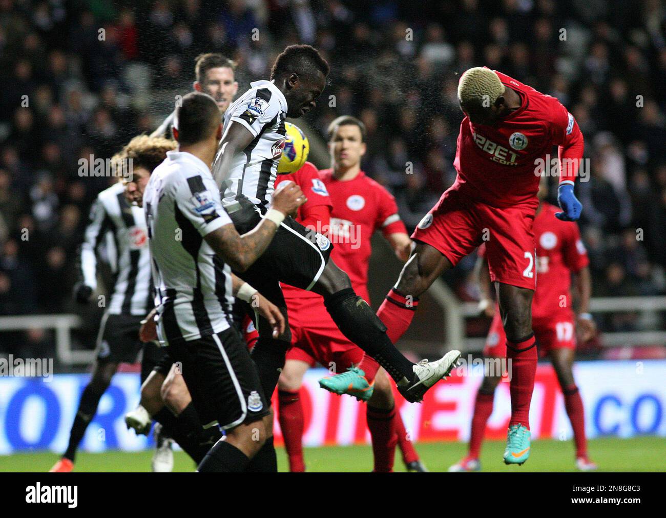 Wigan Athletic's Arouna Kone, right, has a header towards goal past ...