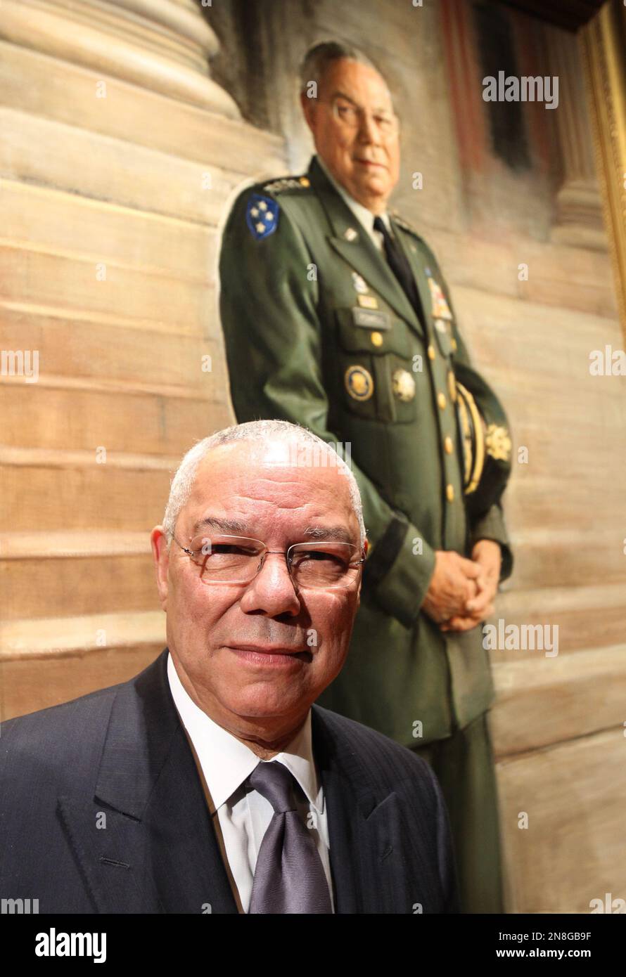 Gen. Colin Powell poses for a photo with his portrait at the ...