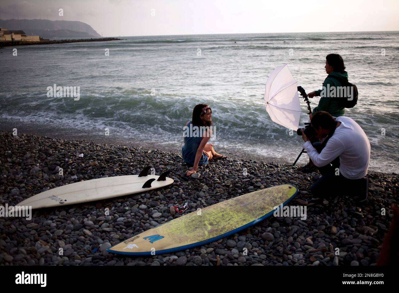 A model poses for advertising pictures at a beach in Lima, Peru, Sunday ...