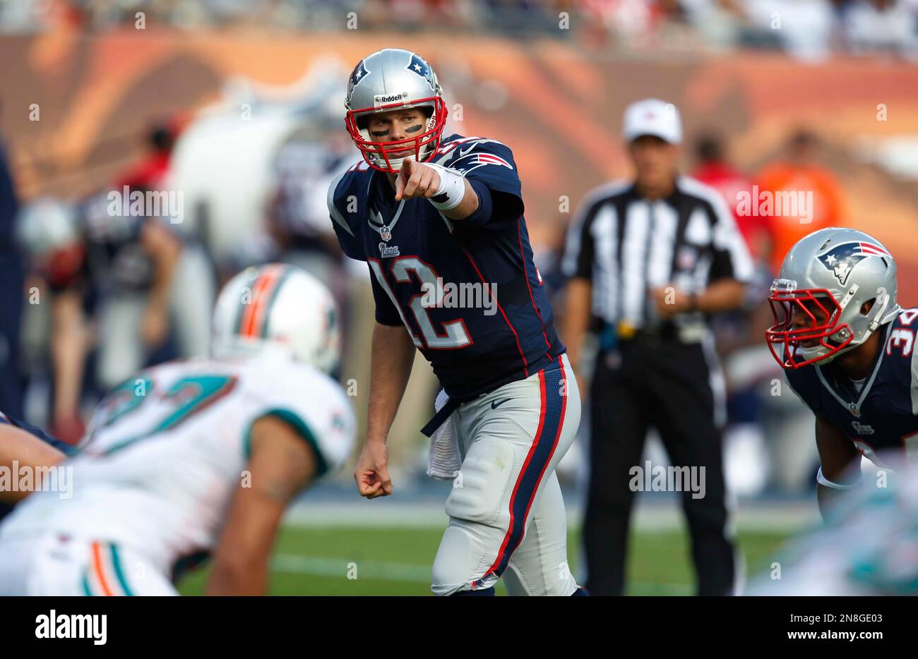 New England Patriots quarterback Tom Brady (12) gestures from the line ...