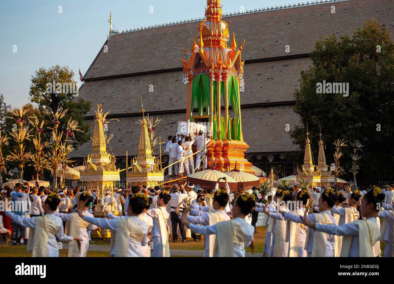 People dressed in traditional costumes lift the coffin into the ...