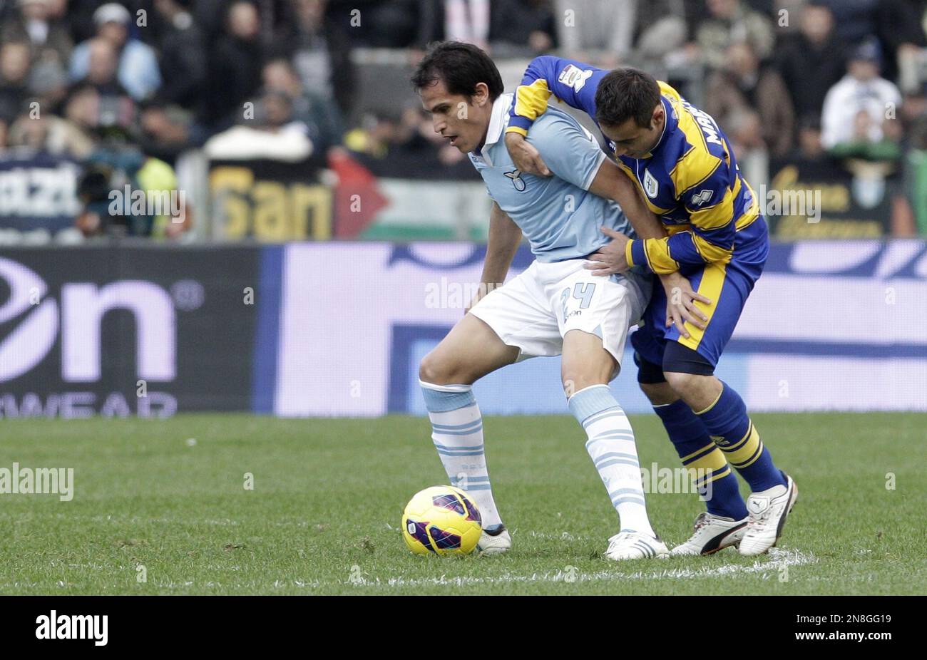 Lazio midfielder Cristian Ledesma is challenged by Parma midfielder ...