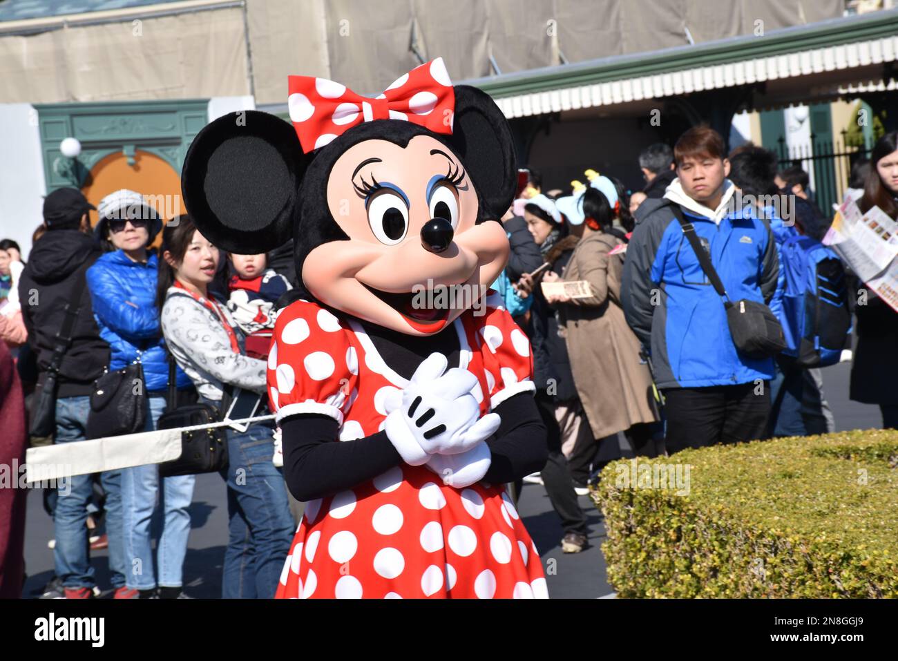 A cute Minnie Mouse at Tokyo Disney land with people in the background ...