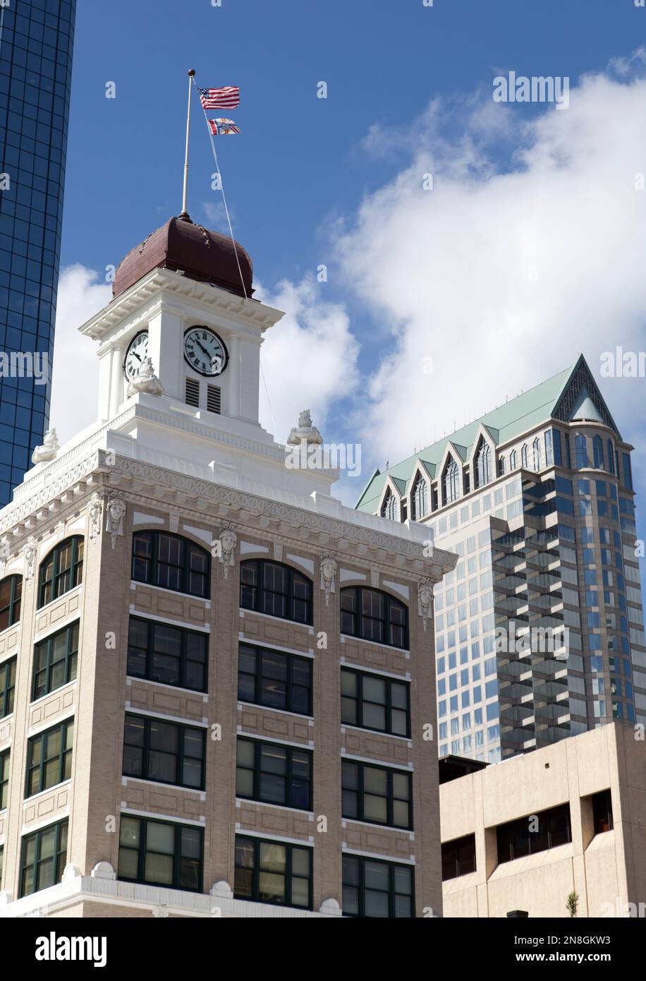 The view of a retro style city hall building with a clock tower and a ...