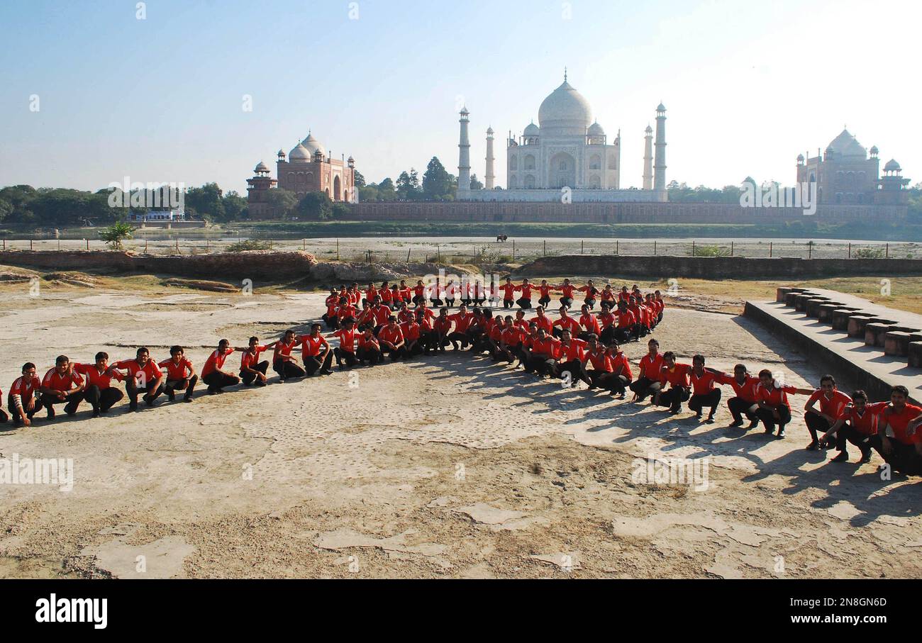 Indian students make a formation in the shape of the red ribbon, the ...