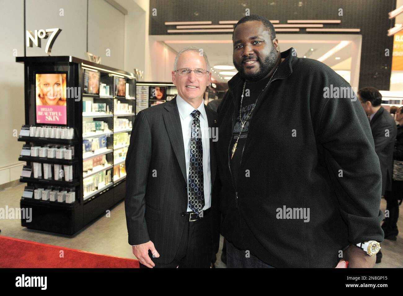 From left, Greg Wasson, CEO of Walgreen Co. and Quinton Aaron attend ...