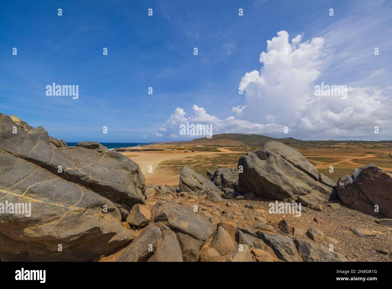 Close-up view of large rocks in desert on Caribbean coast against blue ...