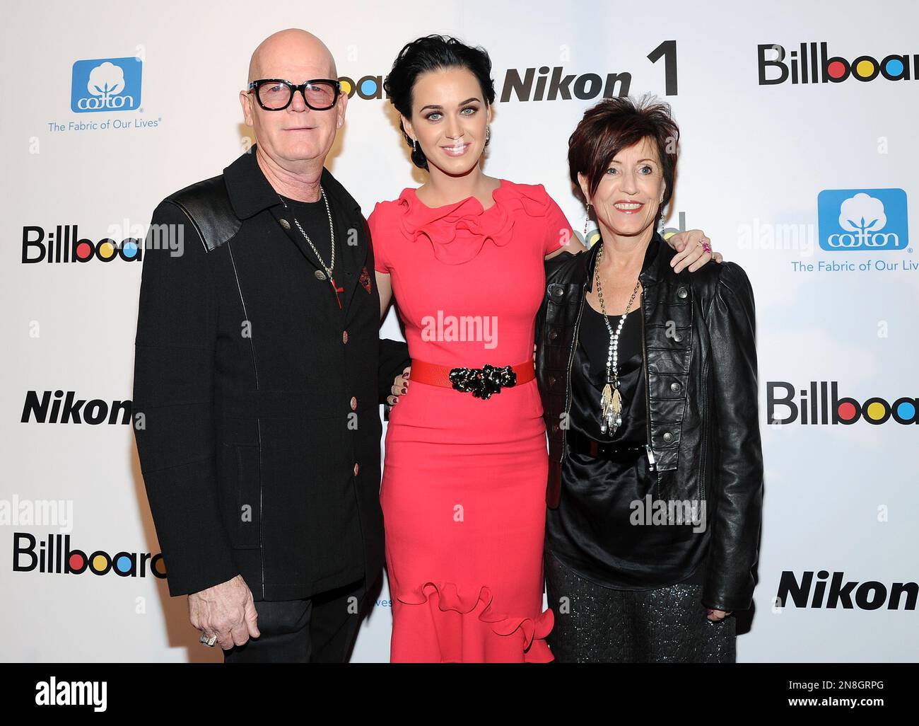 "Woman of the Year" honoree Katy Perry, center, poses with her parents ...
