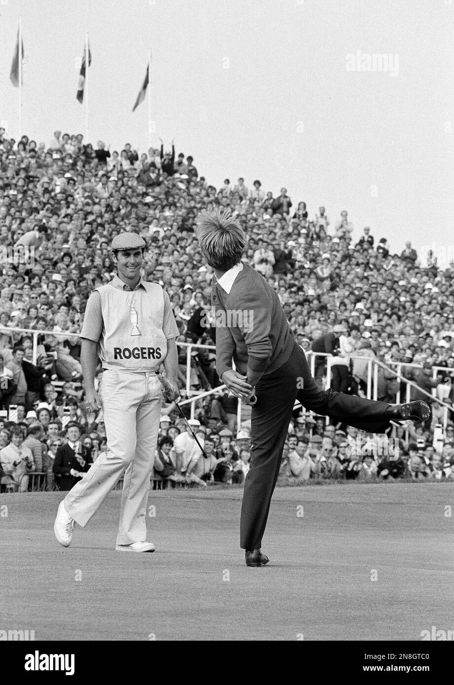 Caddie Chris Frame laughs as golfer Bill Rogers of the U.S. throws his ...