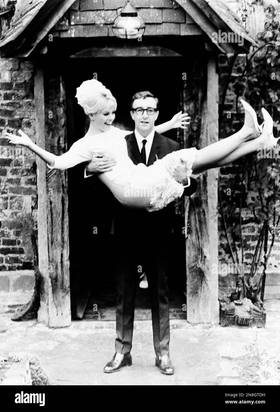 British actor Peter Sellers carries his 21-year-old wife, Swedish ...
