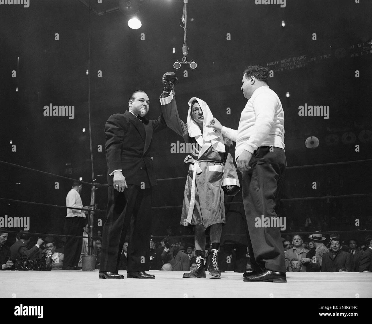Announcer Johnny Addie, left, holds up Willie Pep's hand as he ...