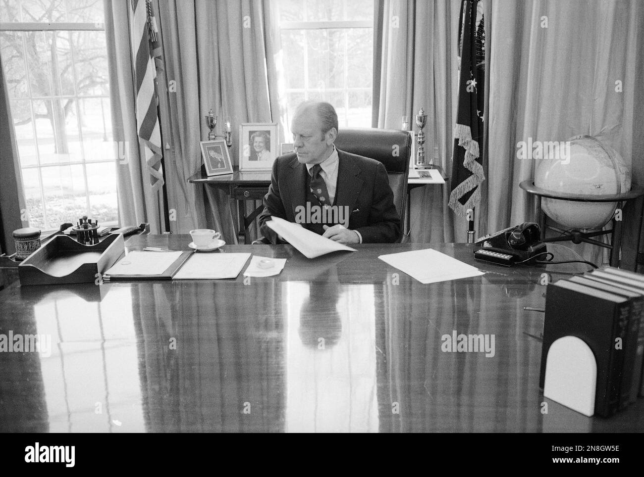 President Gerald Ford is pictured at his desk in the Oval Office of the ...