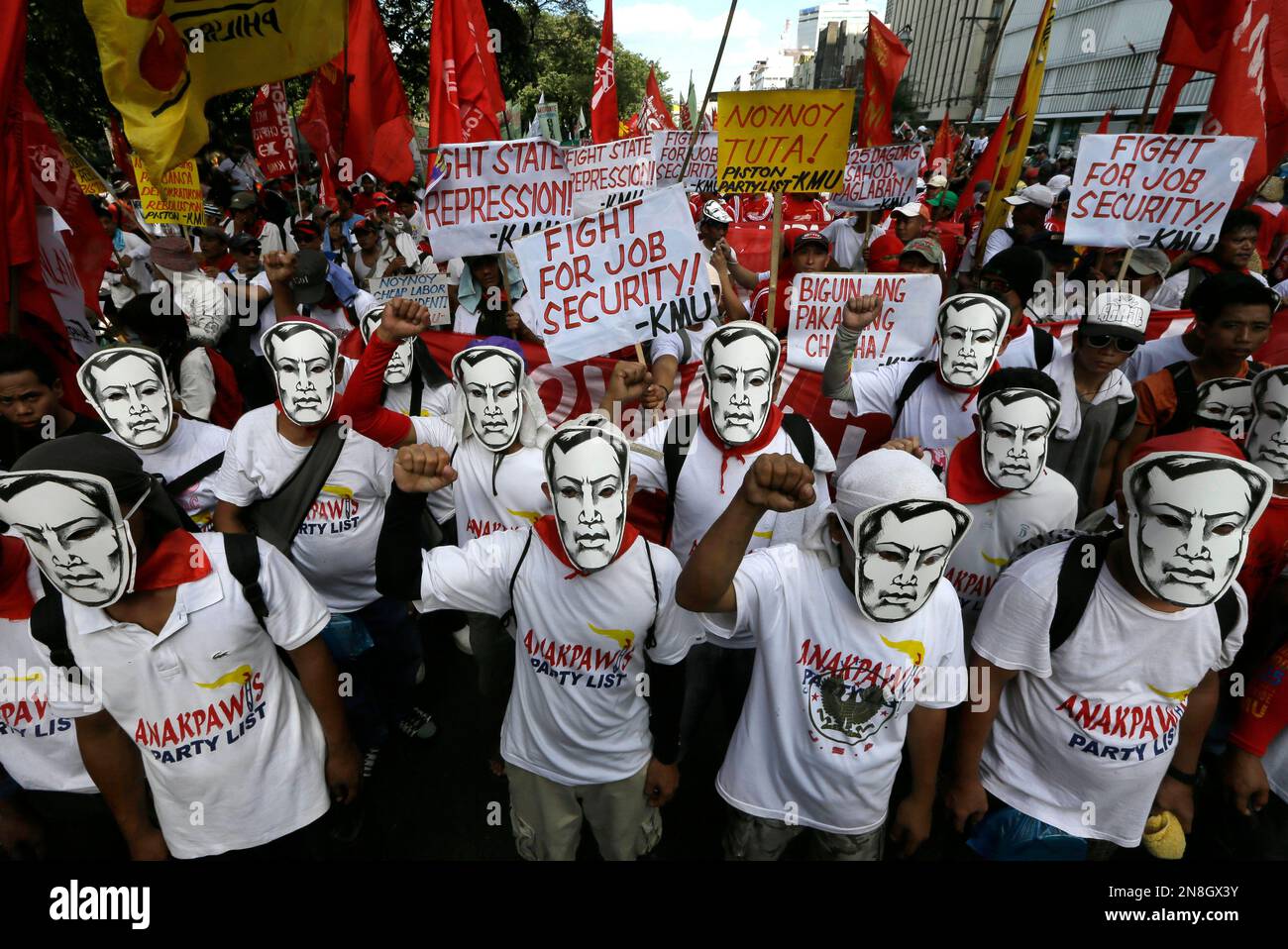 Filipino protesters, mostly laborers, wear masks of the country's ...