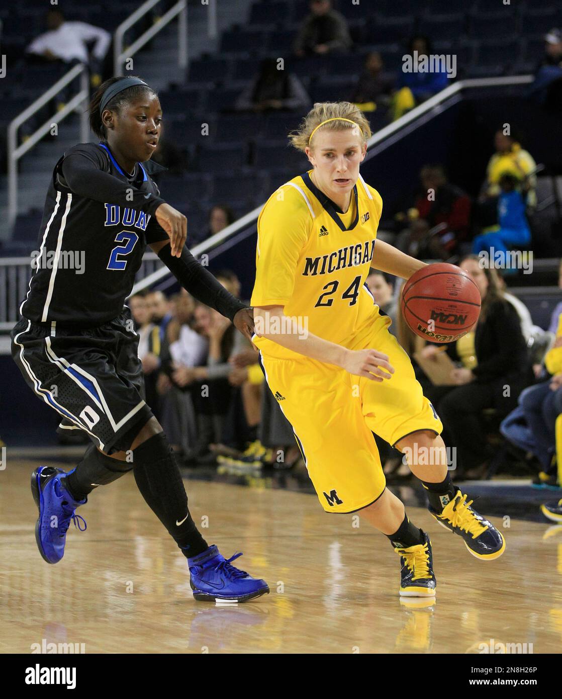 Michigan guard Jenny Ryan (24) drives around Duke guard Alexis Jones (2 ...