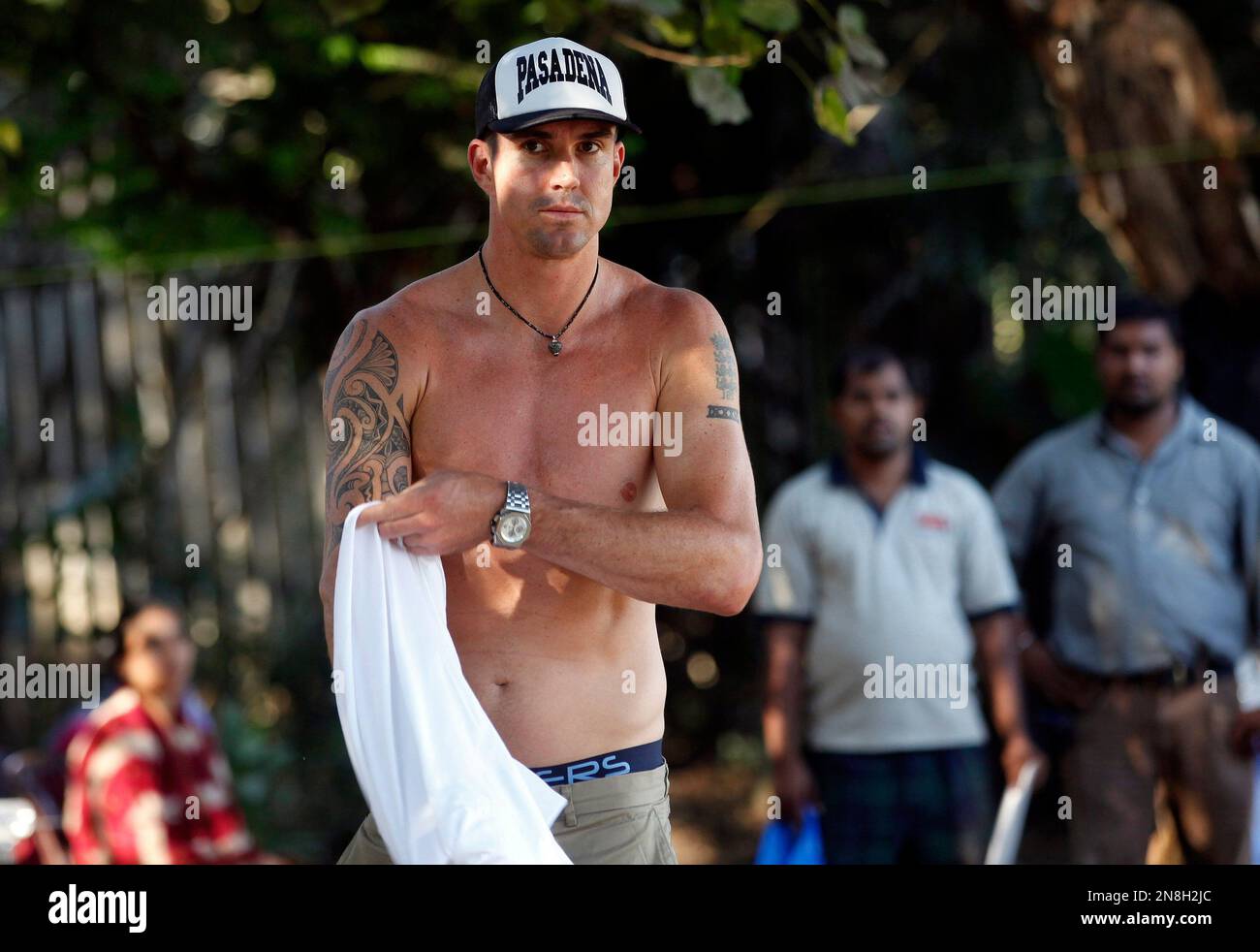 England cricketer Kevin Pietersen, prepares to wear a T-shirt with a ...