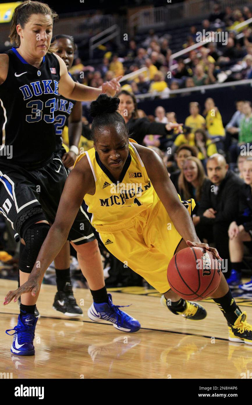Michigan guard Nya Jordan. right,is tripped by Duke guard Haley Peters ...