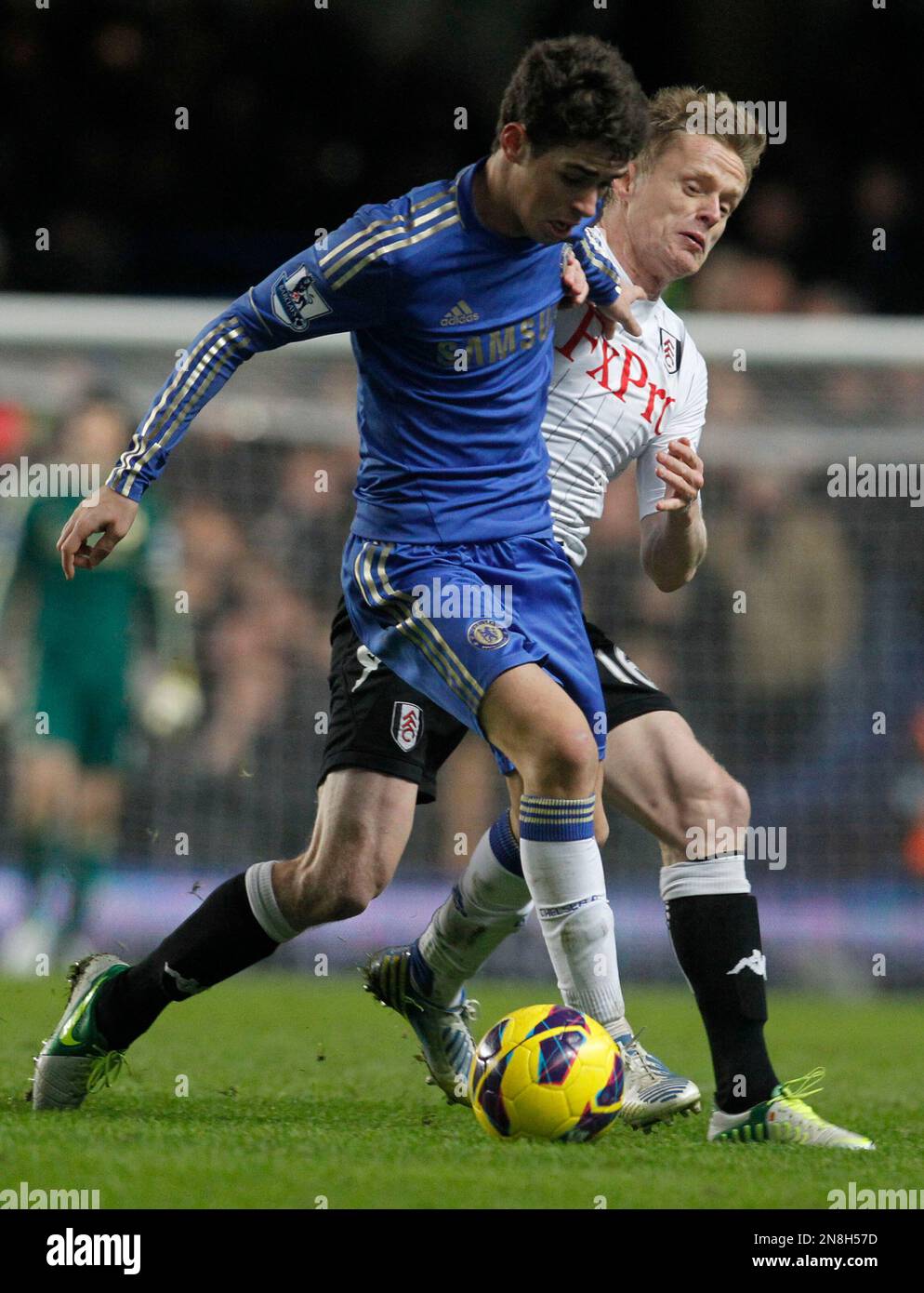 Chelsea's Oscar, left, competes with Fulham's Damien Duff during their ...
