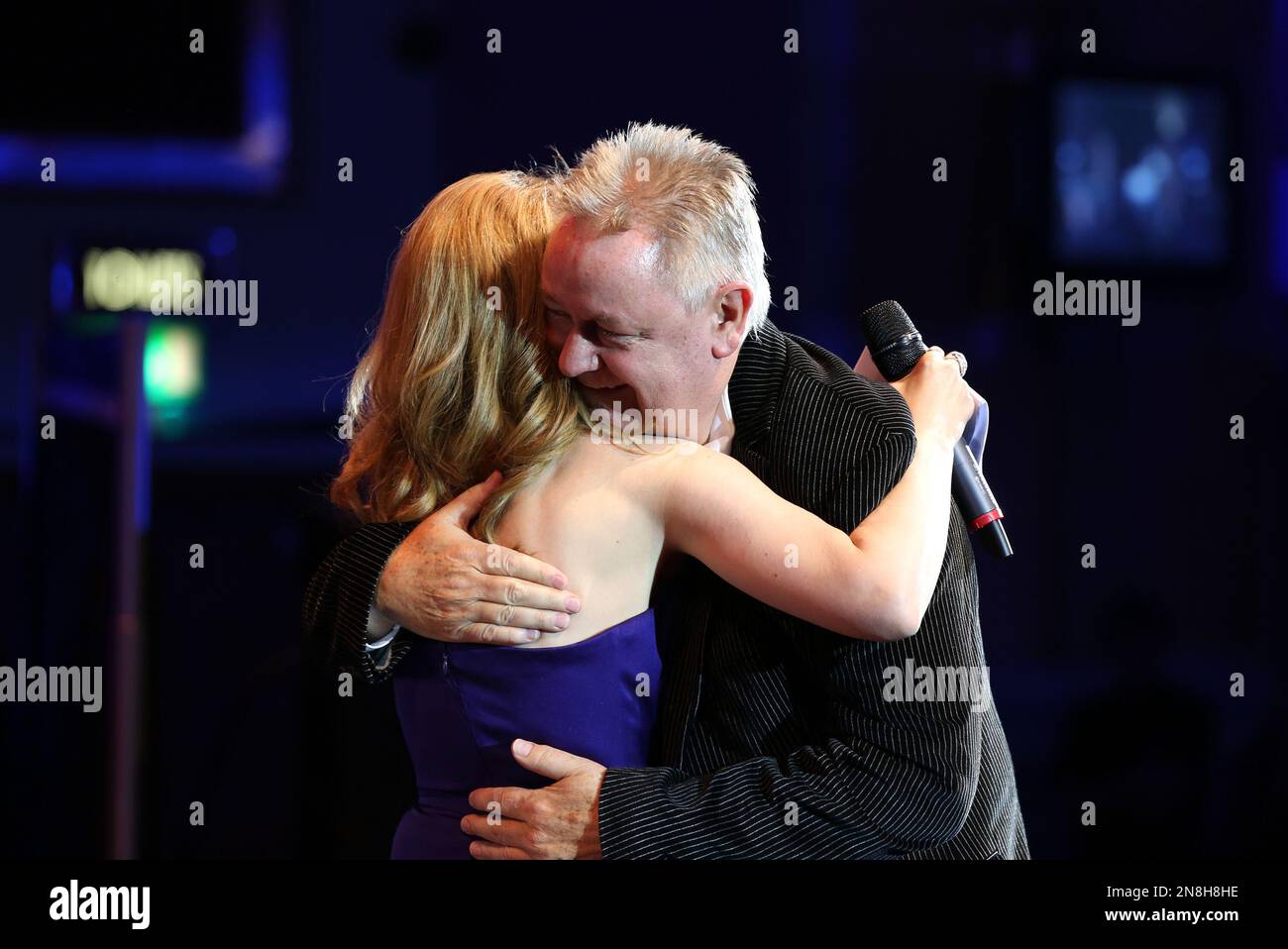 Kylie Minogue, left, embraces Terry Blamey on stage at the Artist and ...