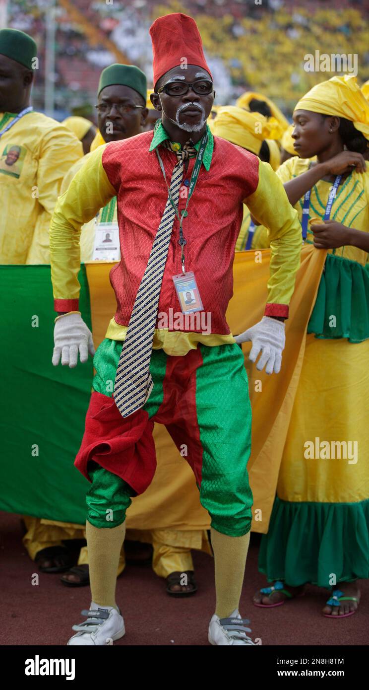 A man dressed like a clown dances during the opening ceremony of the ...