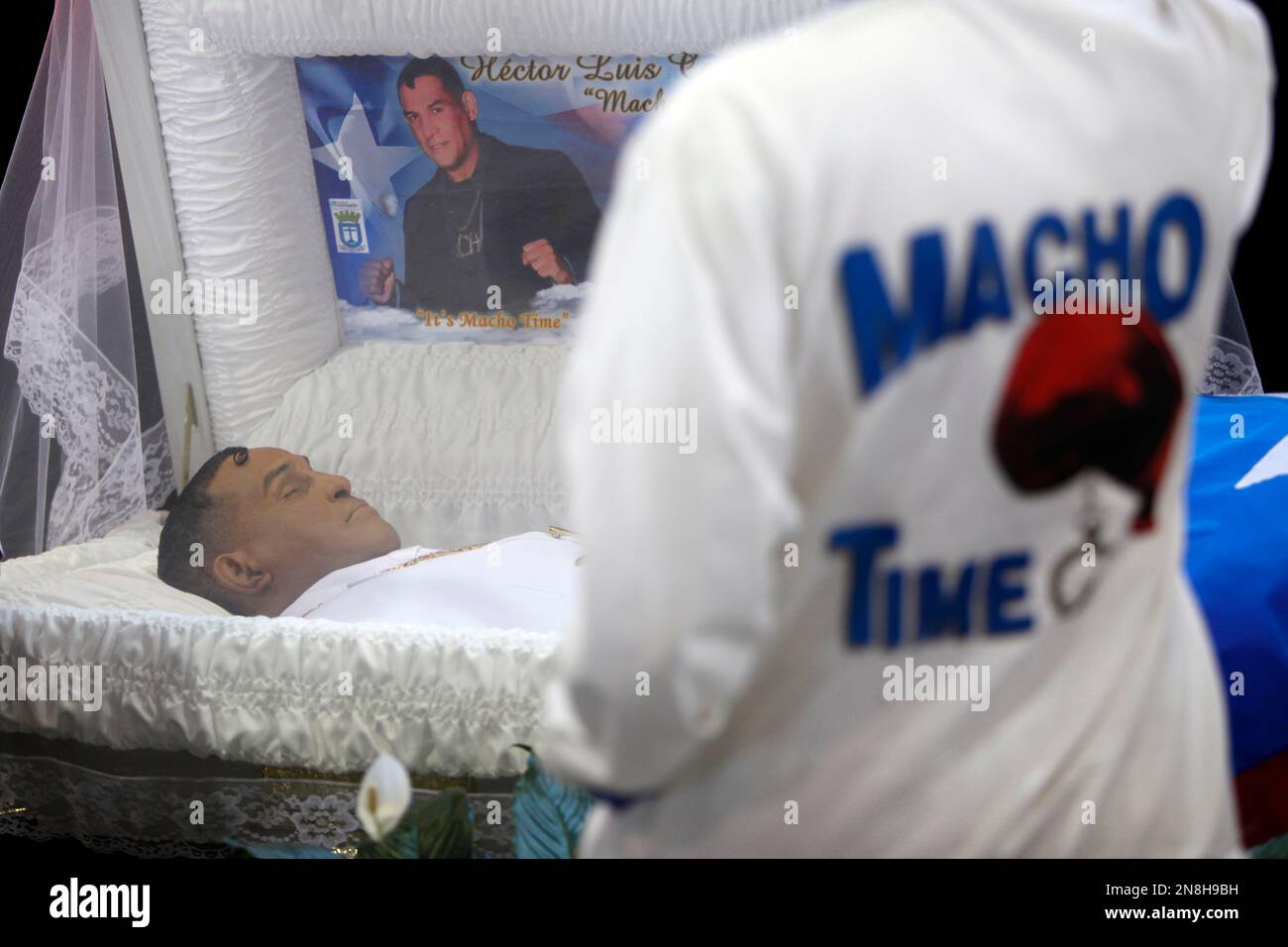 A man stands in front of the casket of former boxing champion Hector ...