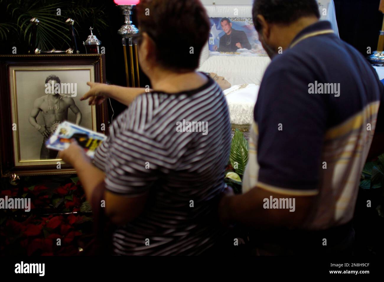 Two people stand in front of the casket of former boxing champion ...
