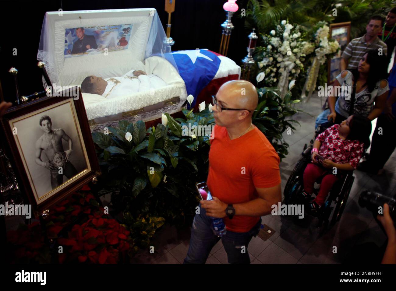 People file past the casket of former boxing champion Hector “Macho ...