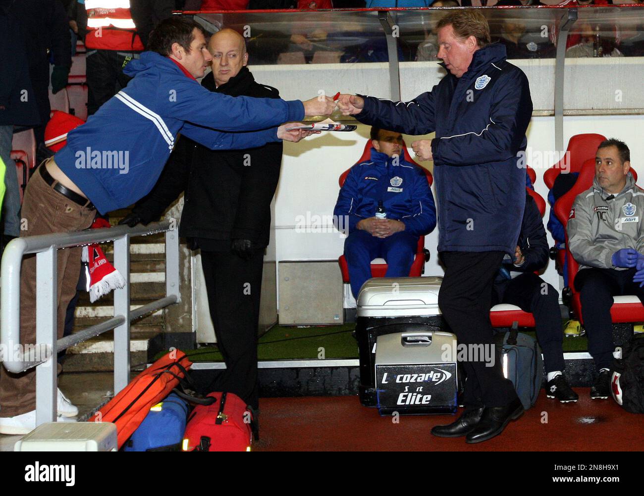 Queens Park Rangers' manager Harry Redknapp, signs an autograph for a ...
