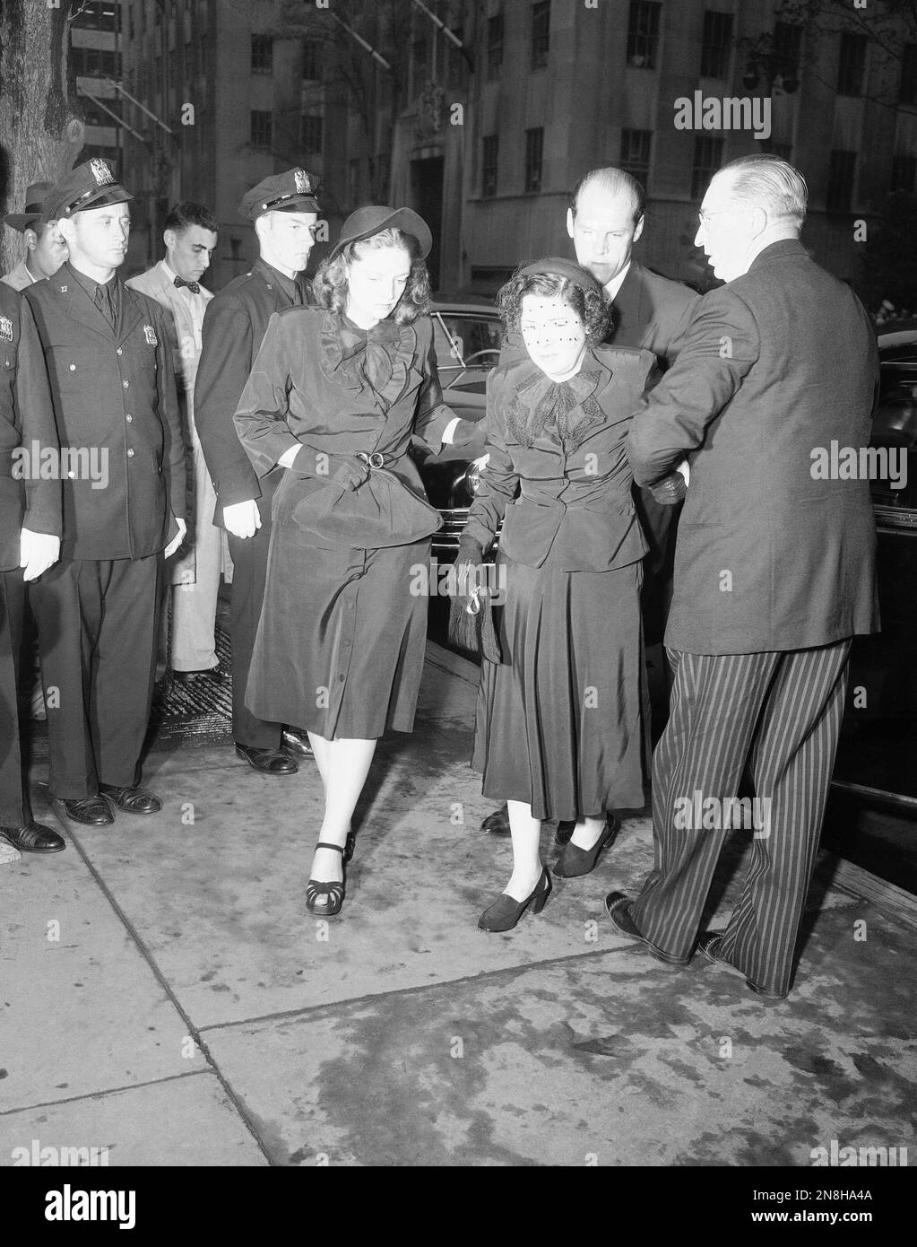 Claire Ruth, center, widow of the mighty slugger, accompanied by the ...