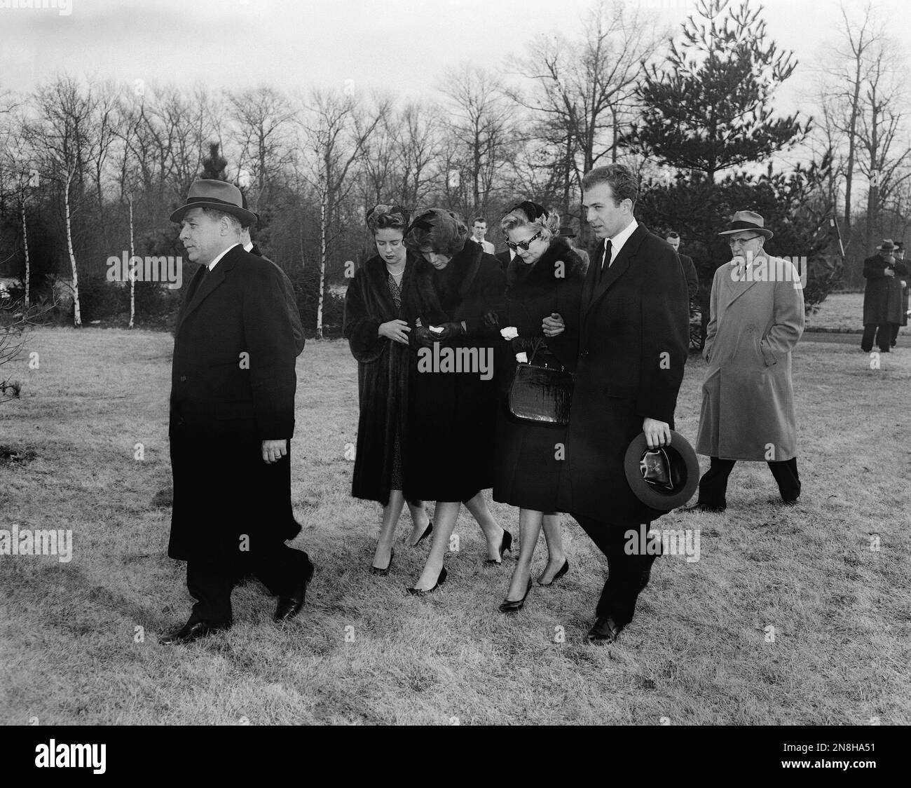 John Steinbach aids his mother Mary, dark glasses, as an unidentified ...