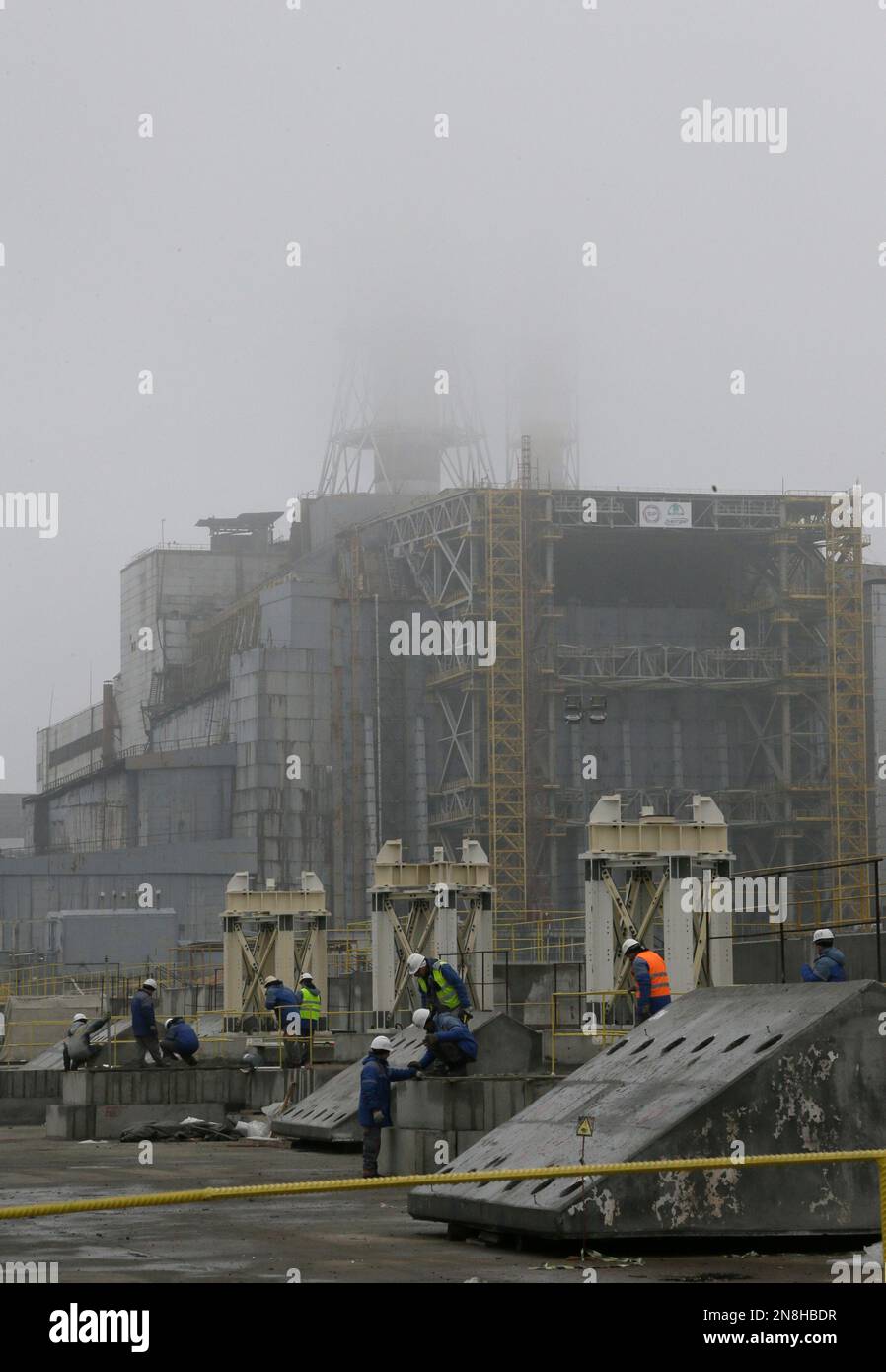 Construction workers assist in the assembly of a gigantic steel-arch to ...