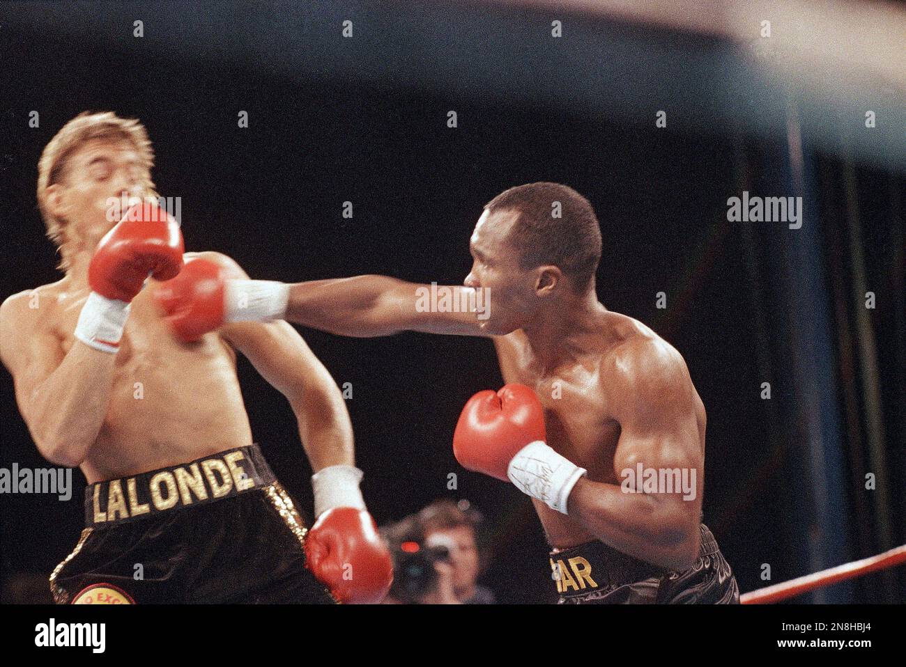 Canadian boxer Donny Lalonde, left, is jarred by a slug from Sugar Ray ...